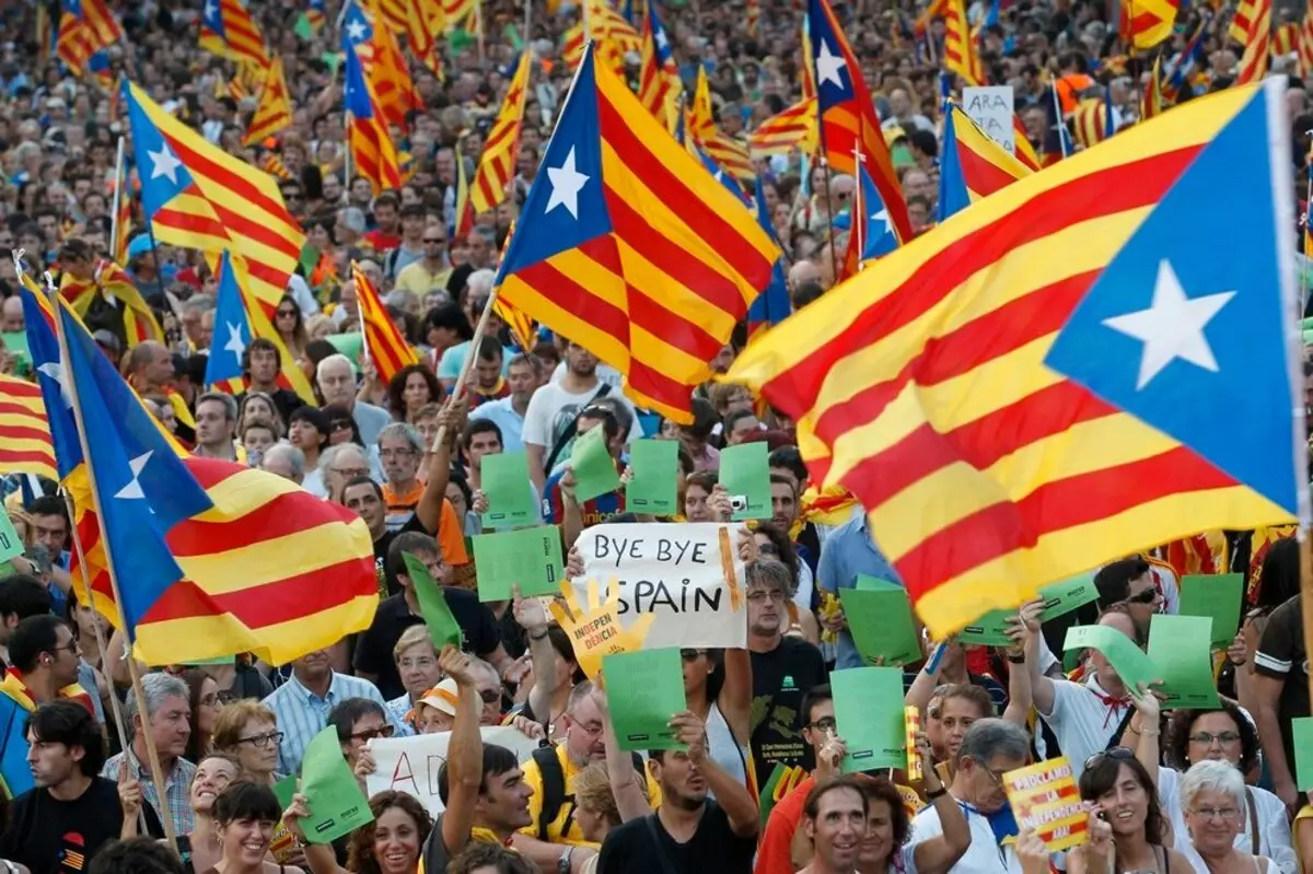 Marchers wave Catalonian nationalist flags as they demonstrate during Catalan National Day in Barcelona